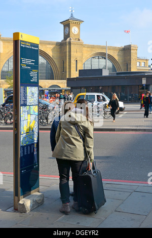 Legible London street sign with refurbished Kings Cross station facade ...