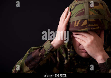 Soldier suffering with P.T.S.D./shell shock with his hand over his face ...