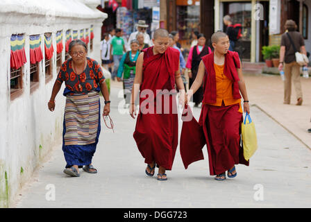Buddhist nuns and pedestrians walk on a road Sunday, Feb. 1, 2026, in ...