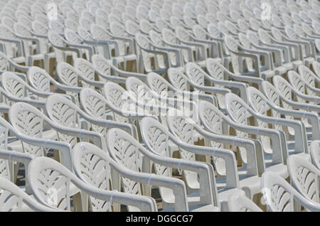 White plastic chairs arranged in rows in an open air concert area Stock ...
