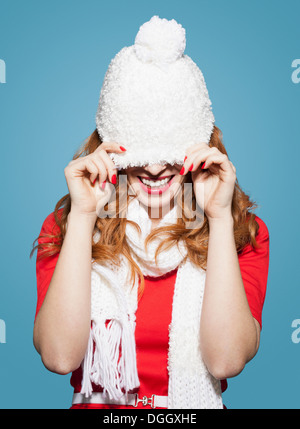 Woman pulling white bobble hat over eyes Stock Photo - Alamy