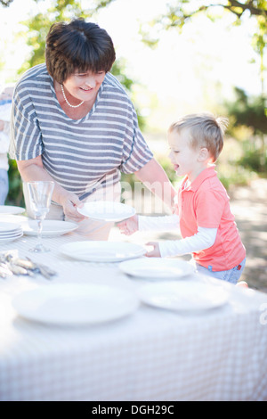 Boy setting the table Stock Photo - Alamy