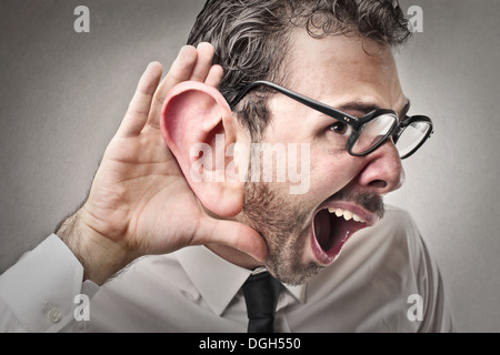 Office worker with glasses can't hear someone Stock Photo - Alamy