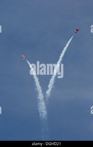 Two RAF Red Arrows perform a near miss during andacrobatic maneuver ...