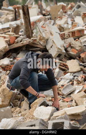 Guy rummaging in a whole lot of construction debris Stock Photo - Alamy
