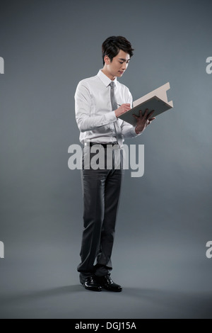 Studio shot business man writing Stock Photo - Alamy