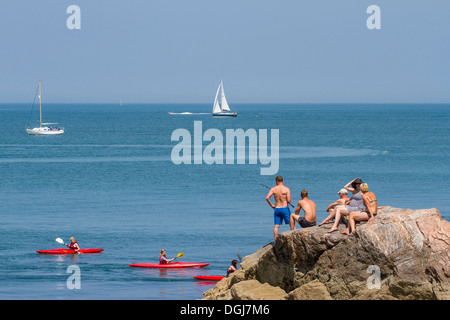 Holidaymakers enjoying the summer sunshine sunbathing on the beach at ...