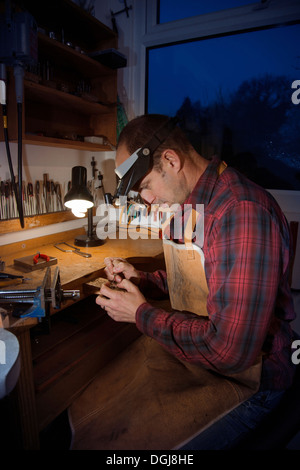 A man working at a silversmith making silver jewelry in Yogyakarta in ...