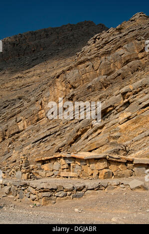 Bedouin stone house matching in colour and texture to the foot of a ...