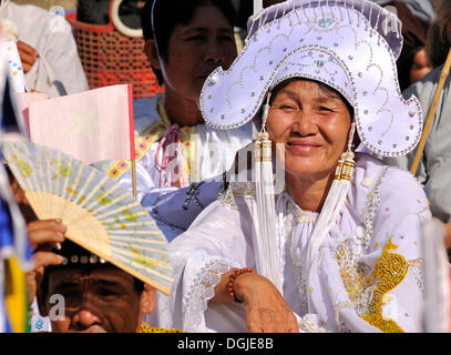 Cham women in traditional dress walking across sand dunes to collecting ...