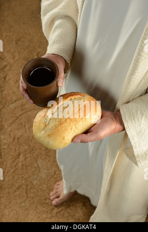 The hands of Jesus offering the Communion wine and bread Stock Photo ...