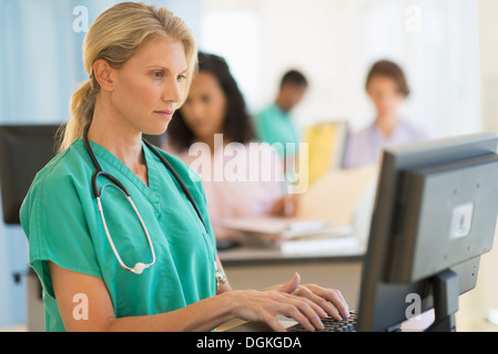 Doctor working at desks in hospital Stock Photo - Alamy
