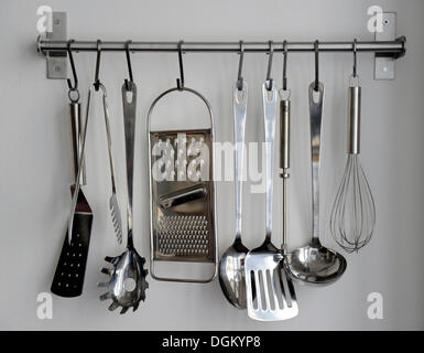 Cooking utensils hanging up in a kitchen in a large restaurant Stock ...