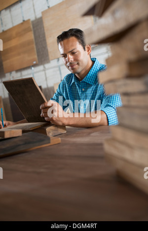 Young hispanic man working on washing machine surprised with an idea or ...