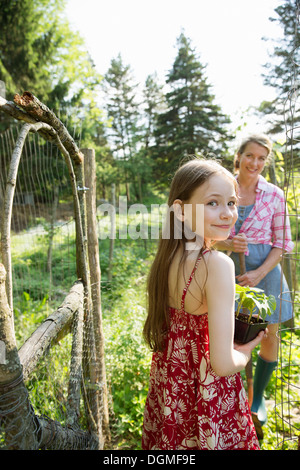 Middle age woman standing over pink background angry and mad screaming ...