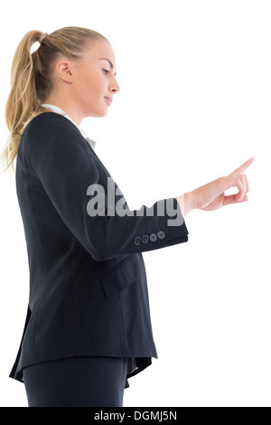 Low-angle view of beautiful blonde housewife typing card number on ...