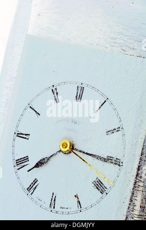 Frozen time. A clock frozen in ice. Extreme weather situation. Daylight ...