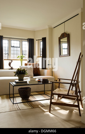 Interior of living room with black sofa and clothes rack Stock Photo ...