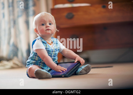 baby boy playing with digital tablet isolated on white Stock Photo - Alamy
