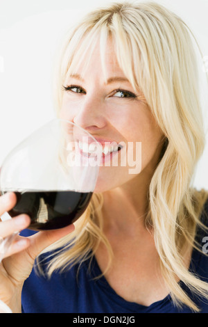 Portrait of smiling woman drinking wine on a family celebration Stock ...