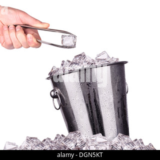 ice bucket with hand holding Ice tongs isolated on a white background ...