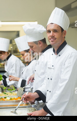 smiling woman chef standing with serving tray in fish restaurant Stock ...