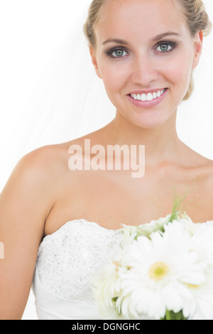 Portrait of a beautiful young bride posing with a bouquet outdoor on ...