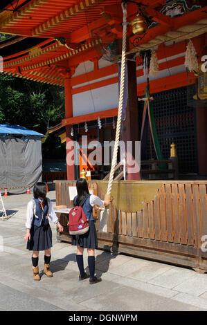 Woman ringing bell at Shinto shrine of Sumiyoshi Taisha, Osaka, Kansai ...