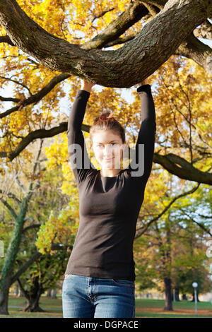 women in park branch tree flower Stock Photo - Alamy