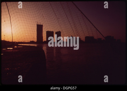 SMELT NETS HANGING FROM LAKE MICHIGAN SEAWALL. HIGH RISE APARTMENTS IN ...