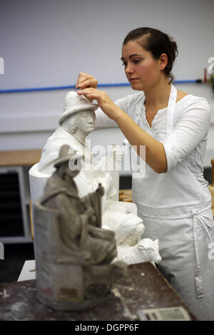 Cologne, Germnany. 24th Oct, 2013. A restorator cleans a figure from ...
