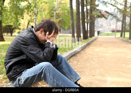 Sad and Lonely Young Man sit at Seaside Stock Photo - Alamy