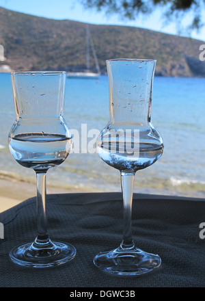 Mastika liqueur in two traditionally shaped glasses ending a meal on ...