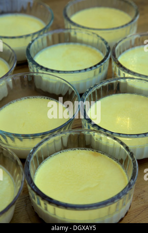 Freshly made crème caramels in individual glass ramekins Stock Photo ...