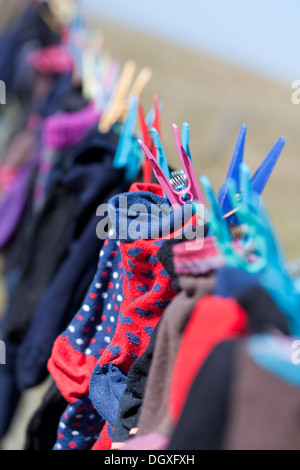 Clothespegs on a clothesline Stock Photo - Alamy