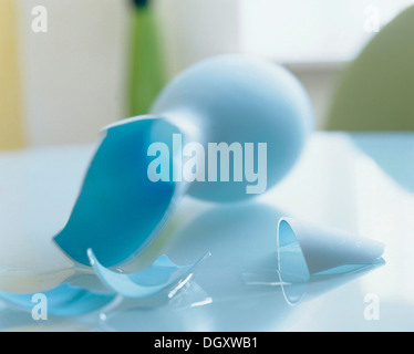 Broken blue glass vase on wooden floor Stock Photo - Alamy