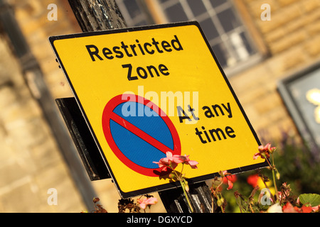 Restricted zone no parking at any time sign on brick wall at Weymouth ...