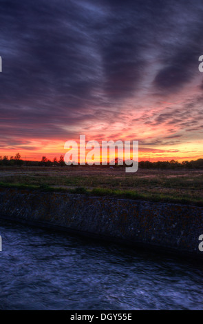 a sunset view in TOULOUSE , in a countryside . A lot of clouds have ...
