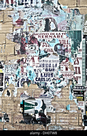 old billboard with ripped advertising posters hanging off in Luton ...