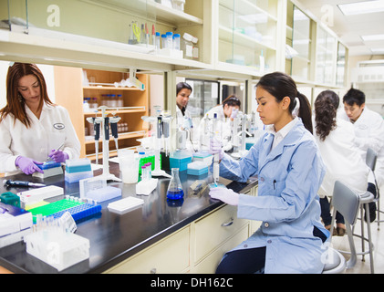 Chinese young woman working at scientist laboratory depressed and worry ...