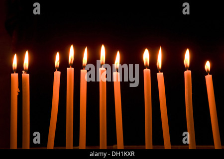 eleven candles burning flame Stock Photo - Alamy