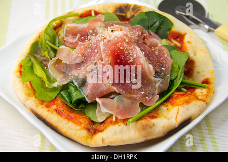 Pizza with raw ham and rocket Stock Photo - Alamy