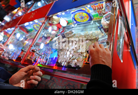 Playing on a penny gambling machine Stock Photo - Alamy