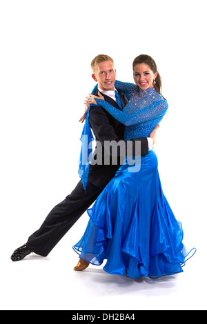 Young ballroom dancers in formal costumes posing against a solid ...