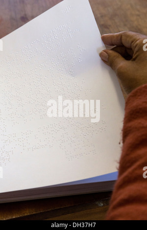 South Africa, Cape Town. Editor Reading a Braille Student Workbook with ...