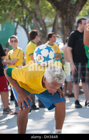 Colorful Brazil fan with a world cup in the stand before the FIFA World ...