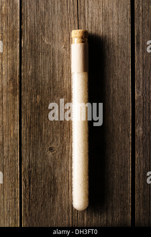 Sea salt in beaker on wooden table Stock Photo - Alamy