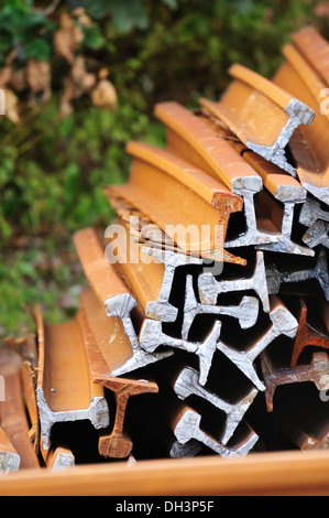 Pile of scrap rail railway railroad track rusty grungy metal plates ...