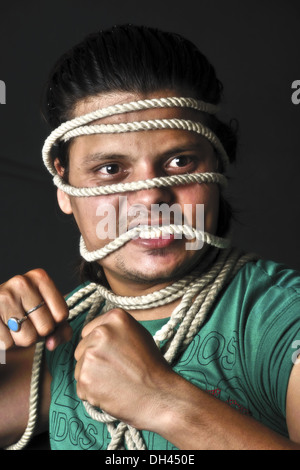 Man tied up with rope on white Stock Photo - Alamy