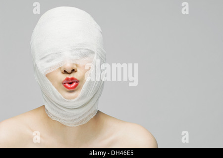 Woman's face wrapped with a bandage Stock Photo - Alamy